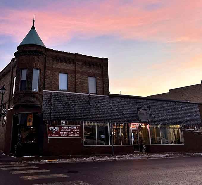 The historic building glows at sunset like it's hiding medieval secrets, which it totally is, along with seriously good pizza.