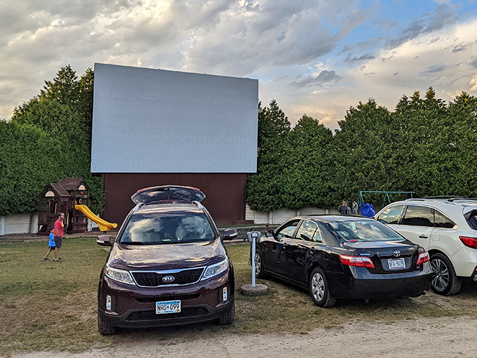 The playground at Skyway Drive-In offers kids a chance to burn energy before the feature presentation. The towering screen waits patiently for darkness.