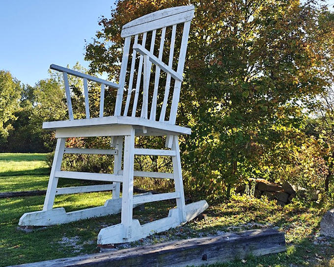 Autumn leaves frame this gigantic rocking chair, creating a surreal sense of scale that makes visitors do a double-take as they drive past.