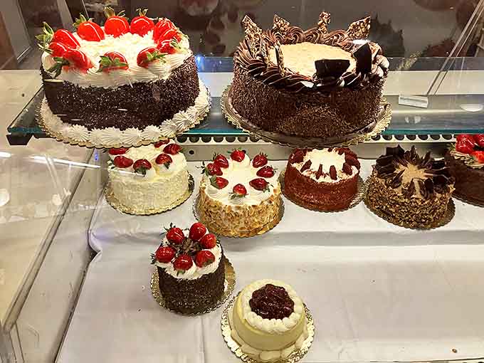 These aren't just cakes; they're architectural marvels where layers of sponge, cream, and fruit create edible skyscrapers crowned with chocolate and berries.