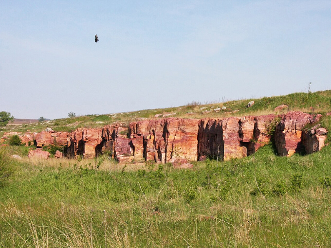 Nature's skyscrapers: Sioux quartzite formations at Blue Mounds State Park create a dramatic backdrop against prairie skies.
