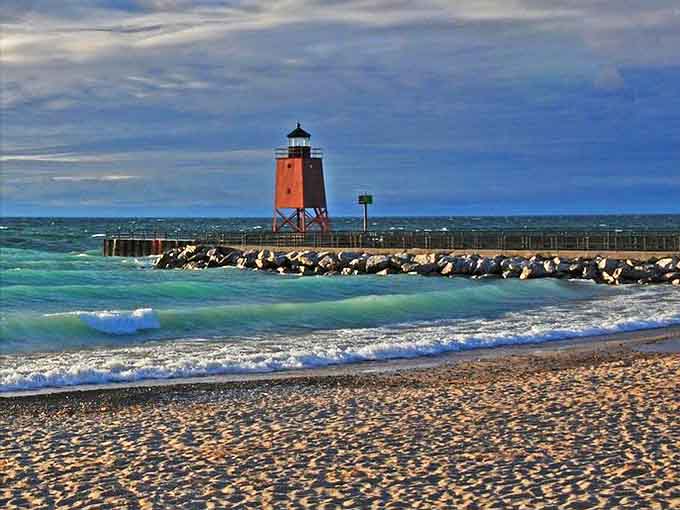 The crimson sentinel of Charlevoix's harbor stands guard where Lake Michigan meets civilization, a photographer's dream in any season.