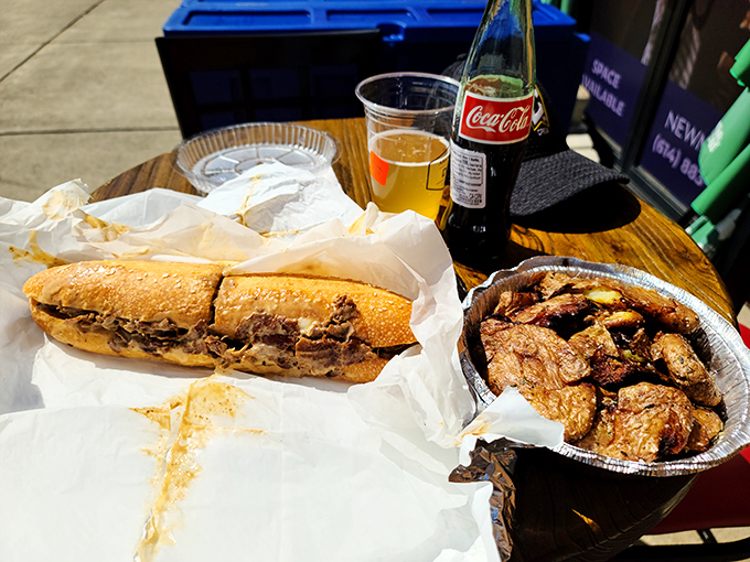 Cheesesteak Lunch: A perfect lunch trifecta—golden-brown cheesesteak, crispy spuds, and an ice-cold drink. Napkins required, regrets impossible.