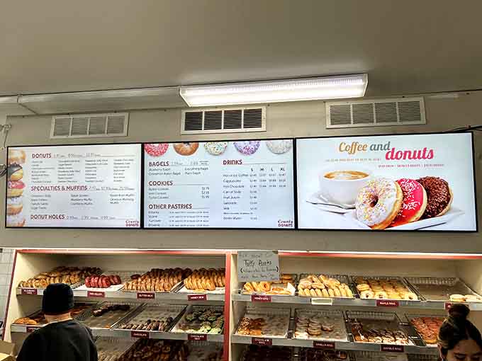 The menu boards promise variety, but let's be real, you're here for those legendary apple fritters everyone keeps talking about.