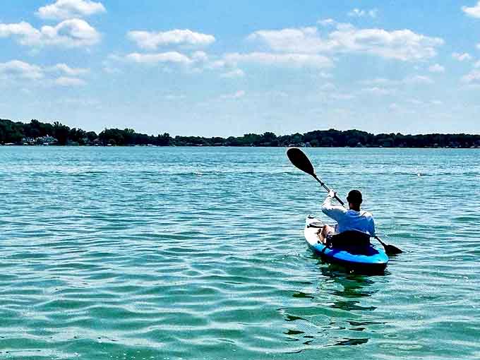 A kayaker glides across Diamond Lake's crystal waters, where recreation and tranquility have coexisted for generations.
