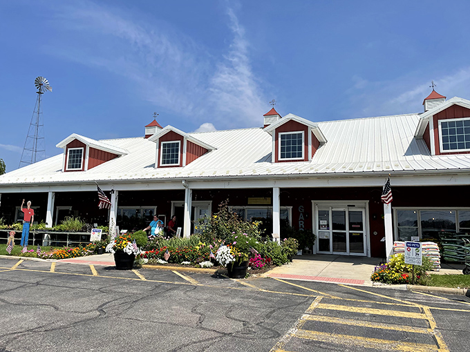 The entrance to Tom's promises farm-fresh delights, with dormer windows peeking out like curious eyes above a porch lined with vibrant flowers.