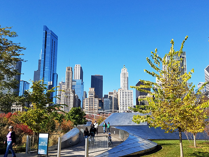 The park entrance welcomes visitors with the promise of adventure, framed by Chicago's iconic skyline peeking through the trees.
