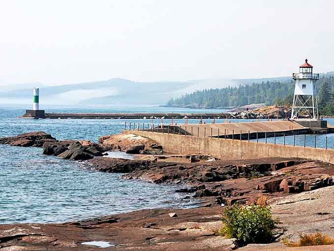Grand Marais's lighthouse keeps faithful watch over the harbor entrance, a steadfast guardian that's witnessed countless sunrises over Lake Superior's vast waters.