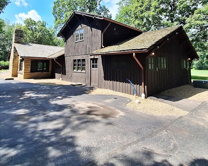 The rustic visitor center stands sentinel at the trailhead, a humble gateway to the natural wonders beyond.