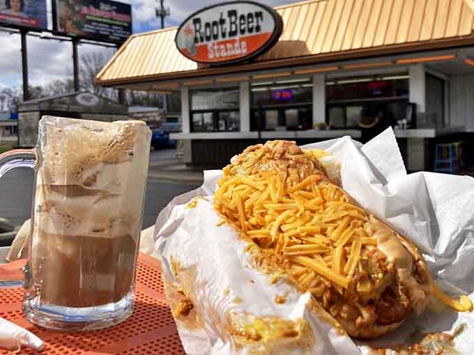 The ultimate pairing: a cheese-smothered hot dog alongside a frosty mug of root beer that puts chain restaurants to shame.