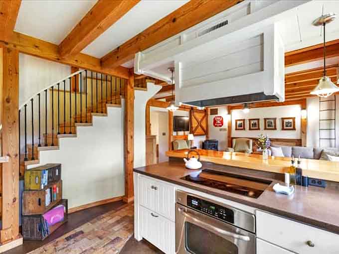 Exposed wooden beams create a cathedral-like atmosphere while keeping things cozy – architecture that hugs you while impressing you.