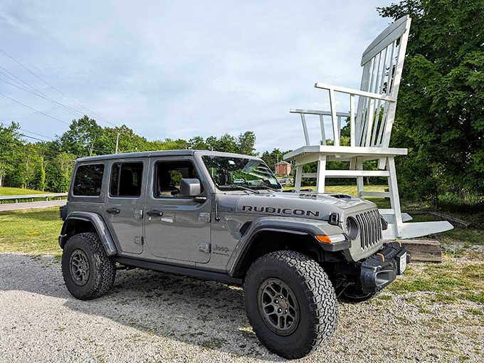 Size comparison that says it all: a Jeep Rubicon looks like a toy car next to Austinburg's famous oversized rocker. Talk about perspective!
