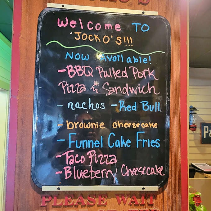 That colorful chalkboard menu is like a treasure map where X marks the spot for BBQ pulled pork, taco pizza, and cheesecake – carb-loading never looked so good.