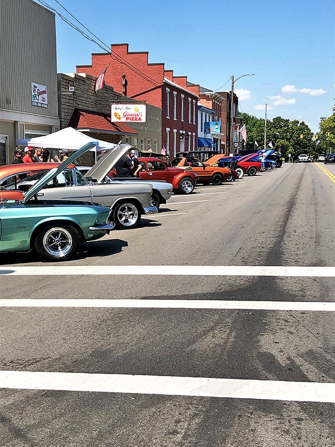 Classic cars line up outside Giovanni's Pizza during a local car show, adding a splash of vintage color to this already timeless town.