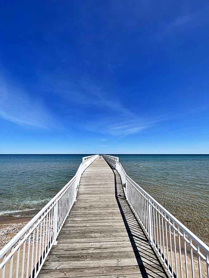 The iconic Lake Huron pier stretches toward the horizon like a wooden runway to tranquility &ndash; each plank a step further from everyday worries.