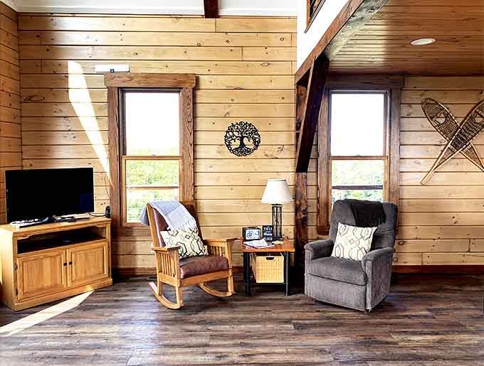 Sunlight streams through windows onto comfortable seating where conversations flow as easily as the views outside &ndash; pure cabin contentment.