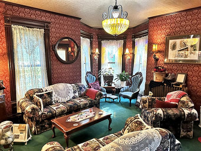 Step into a living postcard of Victorian refinement, where damask wallpaper and period furniture create a parlor straight from another era.