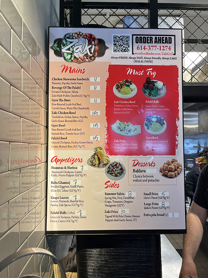 Zaki Grill's menu board tempts with Middle Eastern delights from falafel balls to chicken shawarma, each dish promising authentic halal flavors.