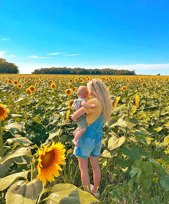 Motherhood meets Mother Nature as this duo shares a quiet moment among thousands of botanical suns, creating memories that will outlast the blooms.