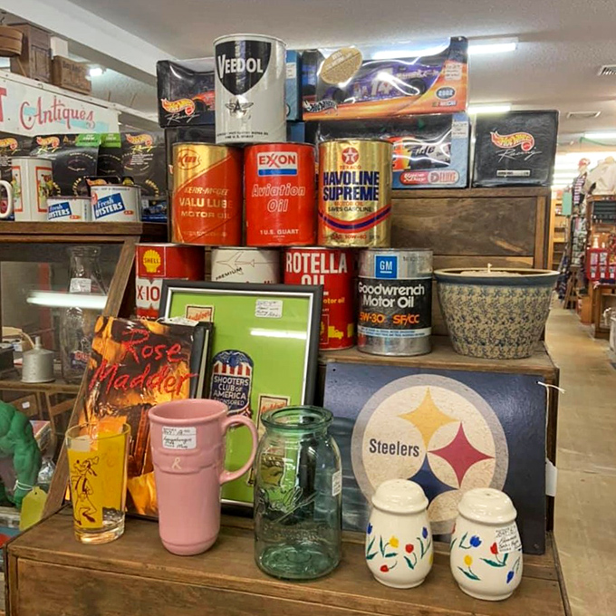 Vintage oil cans from Veedol, Exxon, and Havoline create a colorful tower of industrial Americana, each with its own patina of authenticity.