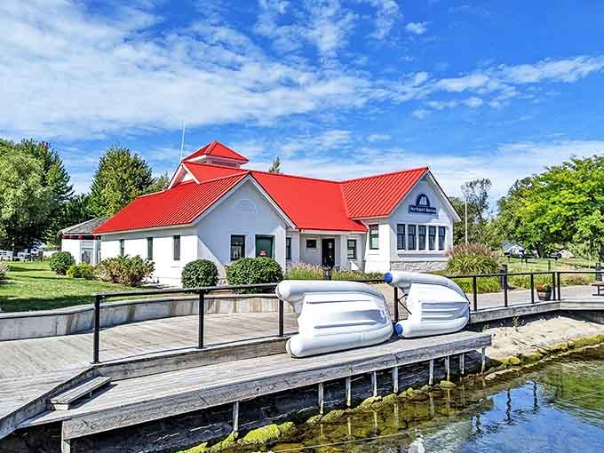 The Marina's distinctive red roof serves as Northport's maritime welcome mat, inviting sailors and dreamers alike to drop anchor.