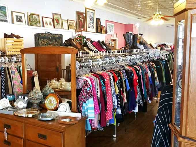 A rainbow of fabrics tells stories of past lives and future possibilities, each hanger a potential fashion revelation.