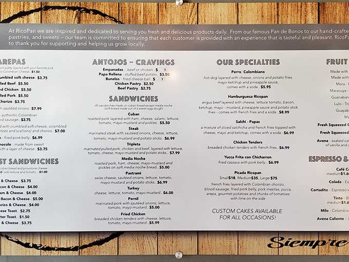 Menu: A treasure map of Colombian delights, the menu board tempts with everything from empanadas to arepas, each promising a flavor adventure.