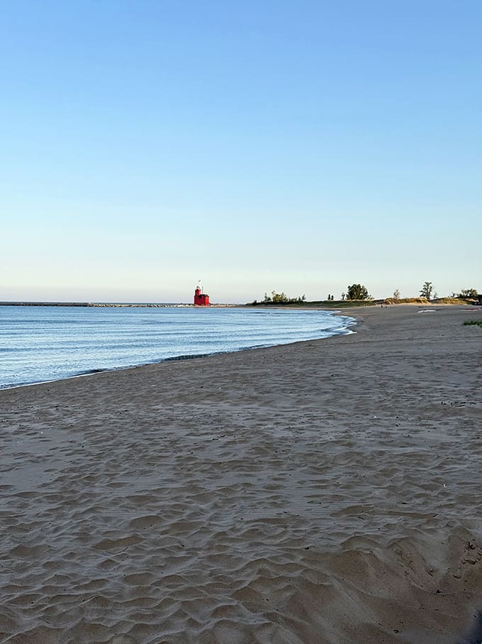 Sandy shores meet blue waters at Holland State Park, where the lighthouse creates a perfect focal point for beach days and sunset watching.