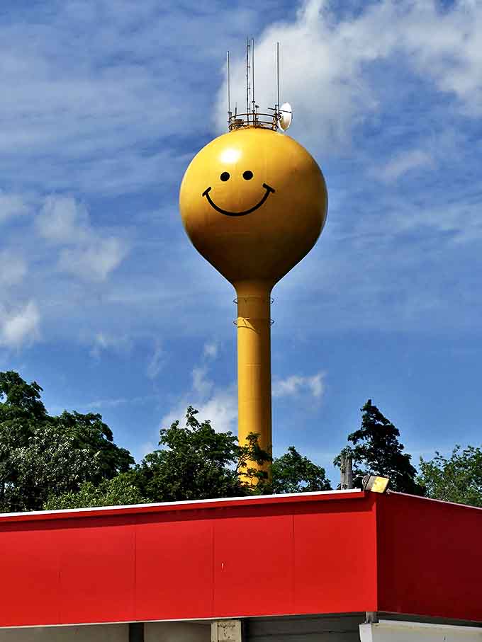 The tower's brilliant yellow face creates a striking contrast against the landscape, visible from miles away on approaching highways.