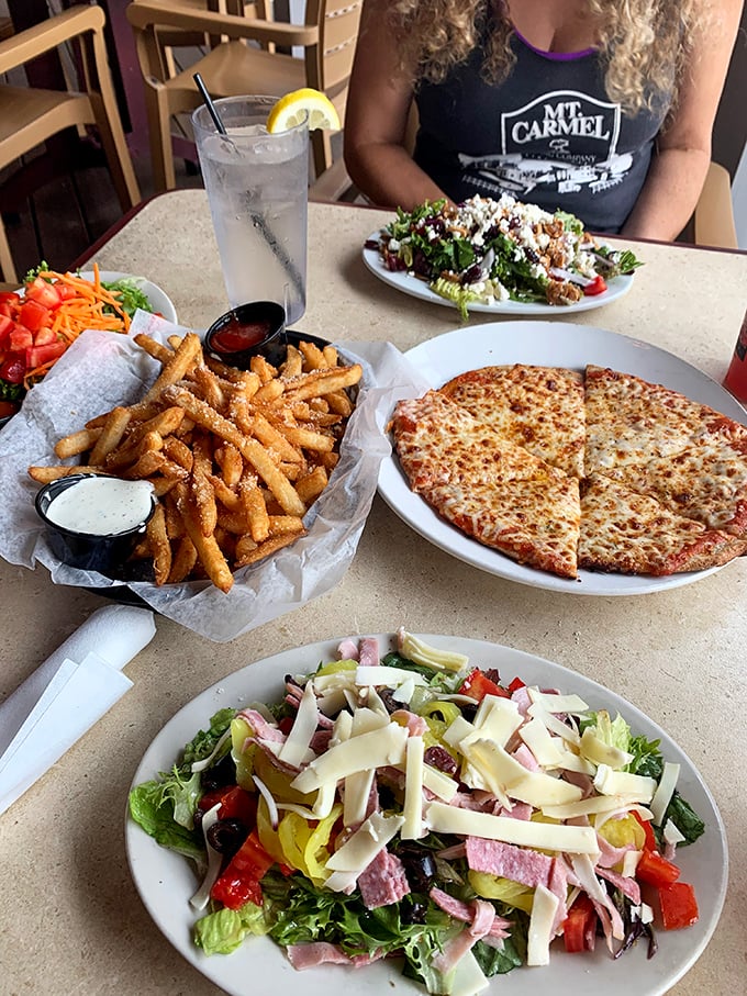 A feast for both eyes and stomach! Golden fries, colorful salads, and that perfectly melted cheese pizza &ndash; this spread screams "cancel your afternoon plans and indulge."