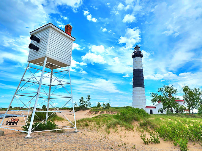 Blue skies and beach grass frame this towering sentinel perfectly, proving that Mother Nature knows a thing or two about composition and dramatic lighting.