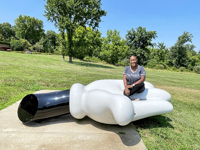 Nothing says "modern art meets childhood nostalgia" quite like lounging on a giant hand that looks straight out of a cartoon.