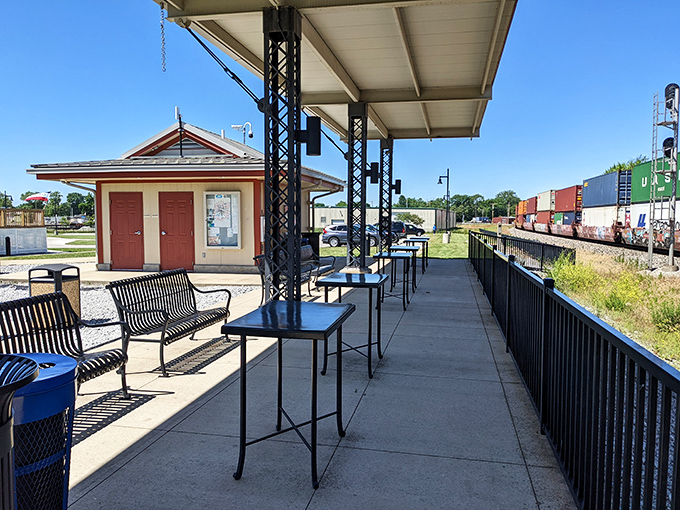 The viewing platform offers front-row seats to the railroad action, with benches perfect for the patient train enthusiast.