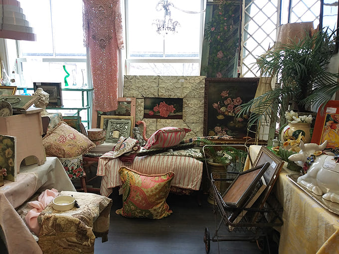 Elegant furniture pieces and decorative pillows create vignettes that show exactly how vintage can work in modern homes beautifully.