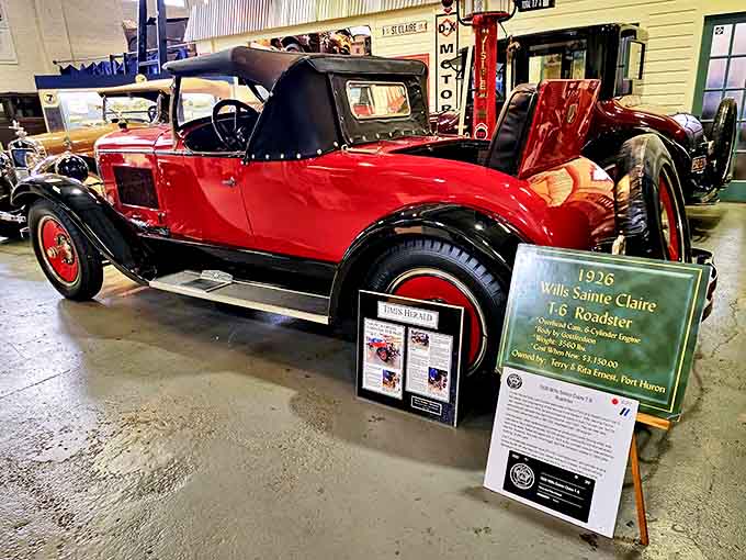 The 1926 Wills Sainte Claire T-6 Roadster gleams in signature red, its flying goose emblem a testament to C. Harold Wills' appreciation for nature.