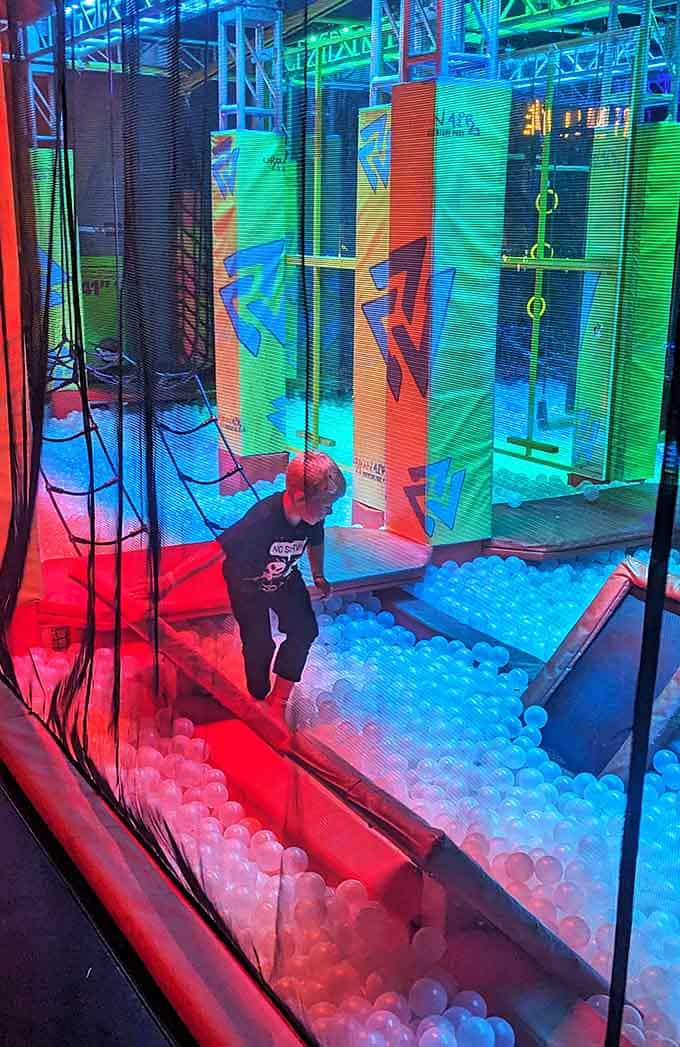 The ball pit area transforms ordinary humans into temporary astronauts, experiencing weightlessness in a sea of plastic spheres and neon lights.