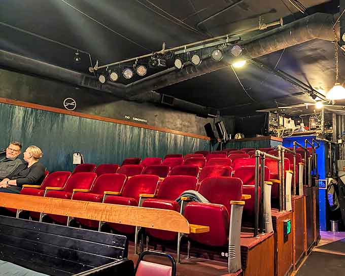 The intimate theater space awaits with its cozy red seats, where artistic magic happens just steps away from bowling action.
