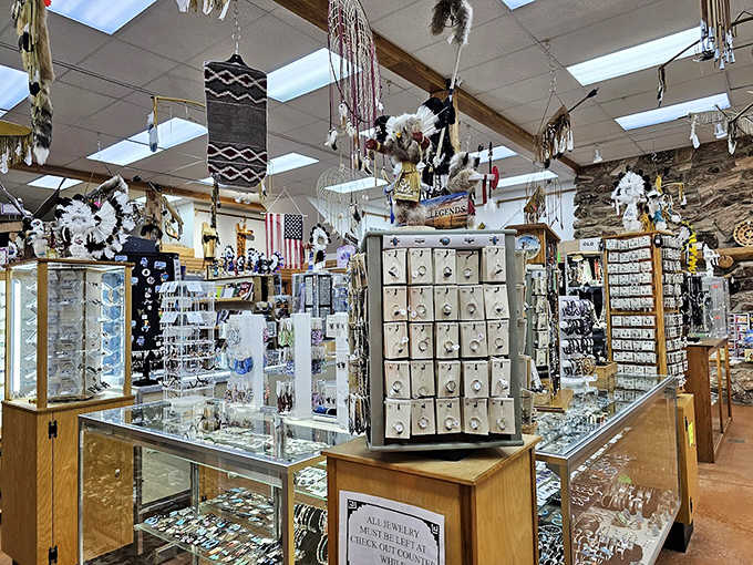 Jewelry cases sparkle under carefully positioned lights, showcasing silver and turquoise pieces that tell stories through stone and metal craftsmanship.