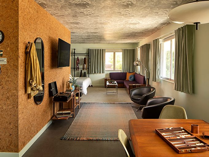 Cork walls and plush seating create a living space that feels both retro and remarkably current.