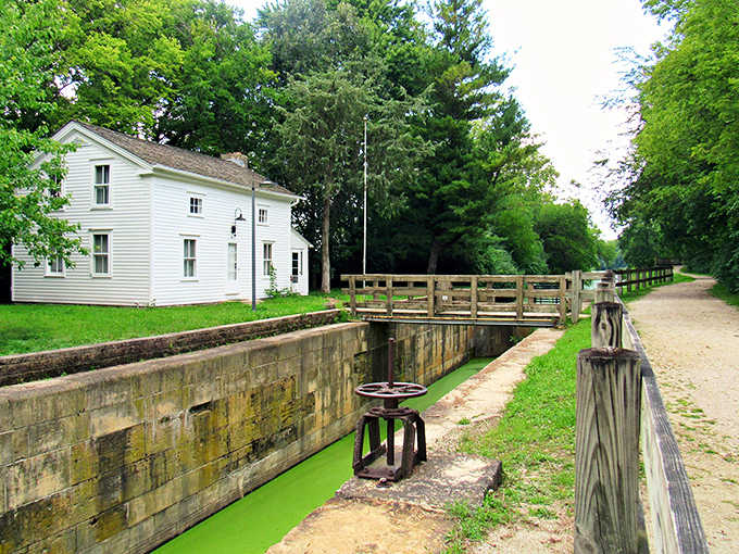 The lockkeeper's house stands as a white sentinel to canal history, where someone once lived and worked managing the water traffic that built the Midwest's economy.