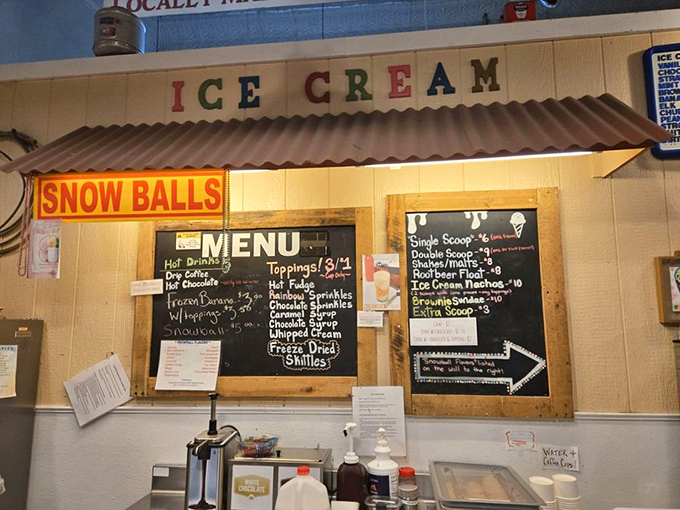 The handwritten menu board showcases daily offerings from hot fudge sundaes to snow balls, each promising a different path to dessert nirvana.