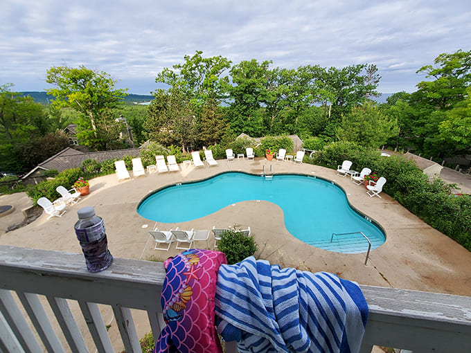 Lounge chairs surround a sun-dappled pool where vacationers debate life's important questions: nap now or nap later?
