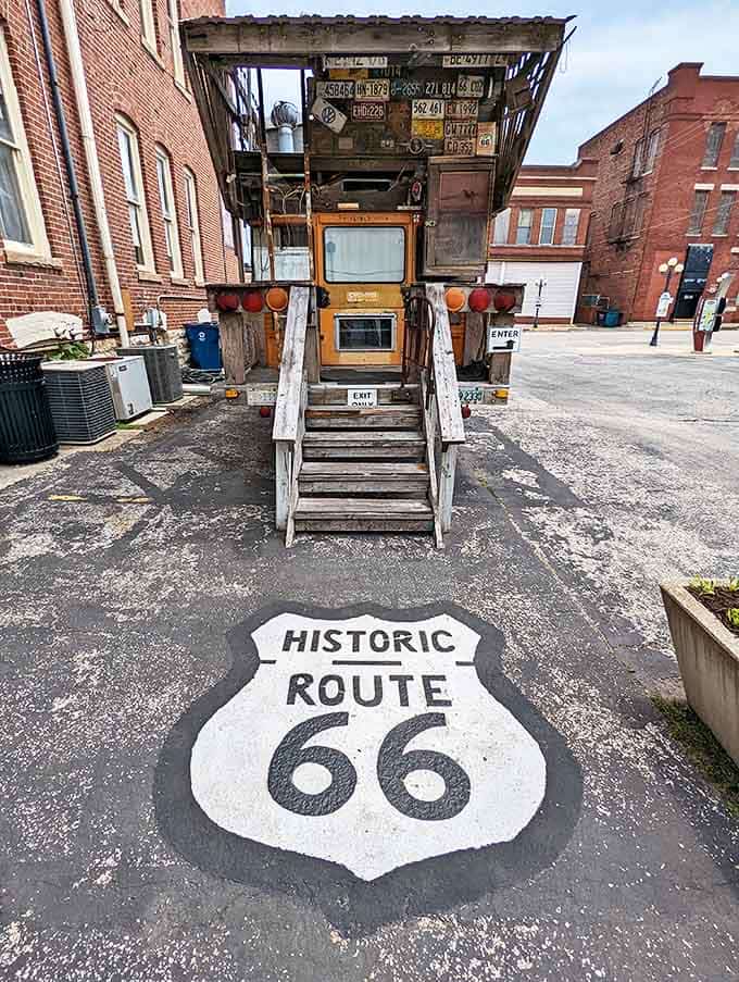 Nothing says "photo opportunity" quite like a weathered camper bus with the Mother Road's iconic shield painted right on the pavement beneath it.