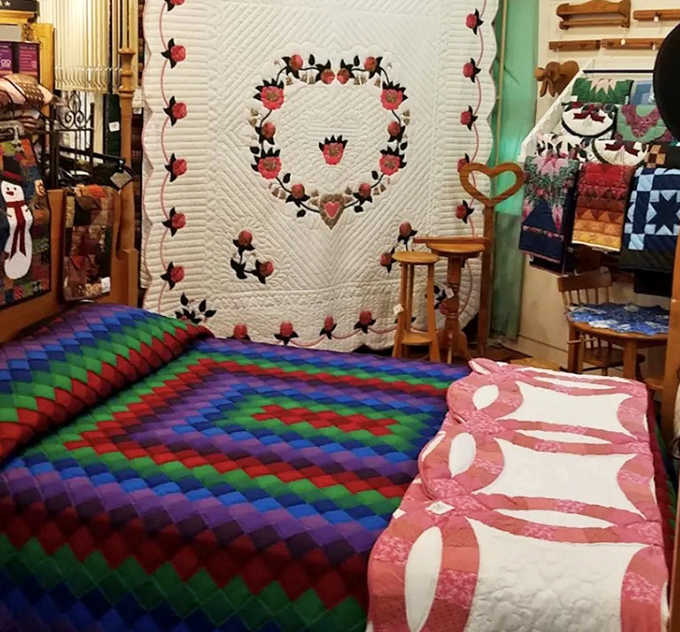 A rainbow of geometric precision unfolds across these handcrafted quilts, where traditional patterns meet contemporary color palettes.