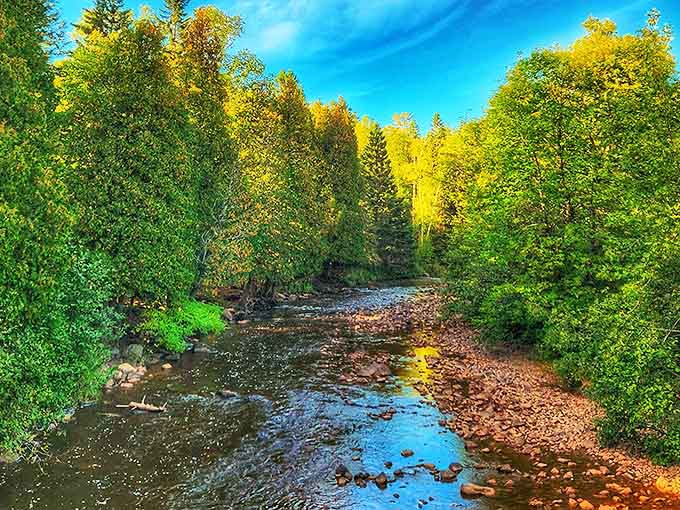 Sunlight dances on the gentle current of the Gooseberry River, where smooth stones create nature's own stepping stones through the crystal-clear water.