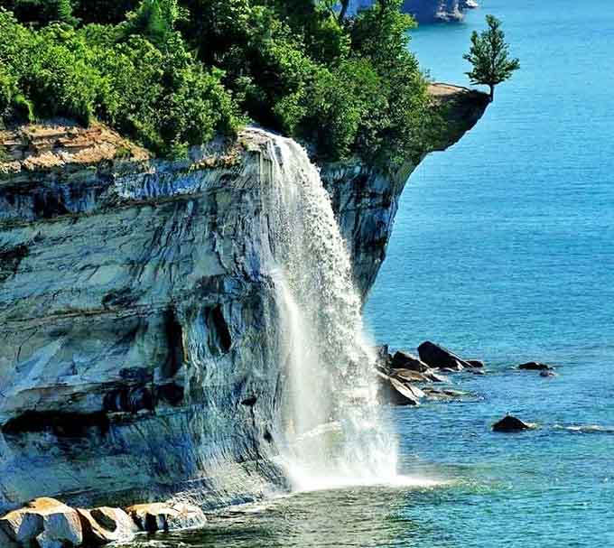 The cliffs rise like ancient sentinels while water takes its daily plunge, creating a scene that belongs on every bucket list.
