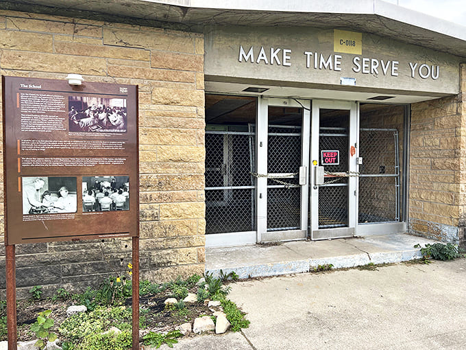 "Make Time Serve You" &ndash; the ironic entrance sign welcomes visitors to the prison's educational building, a rare beacon of hope within the walls.