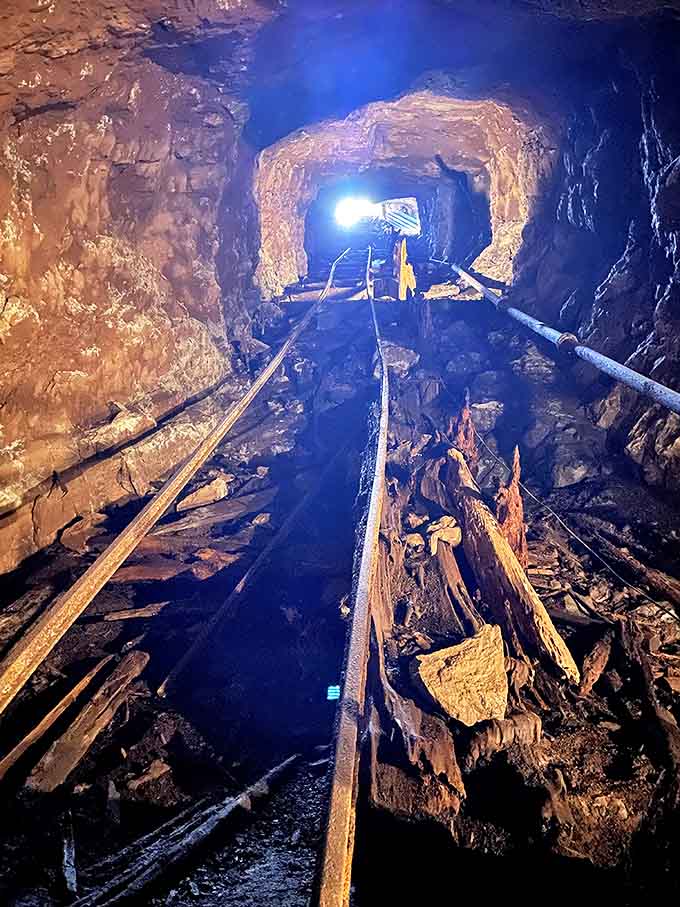 Ancient mining rails stretch into darkness, silent witnesses to the backbreaking labor that built America's industrial might.