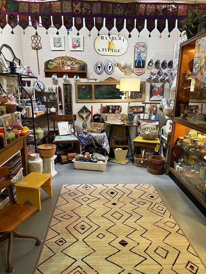 This Banbury Vintage booth showcases the art of display &ndash; geometric rugs, framed curiosities, and carefully arranged treasures create a miniature museum of everyday history.