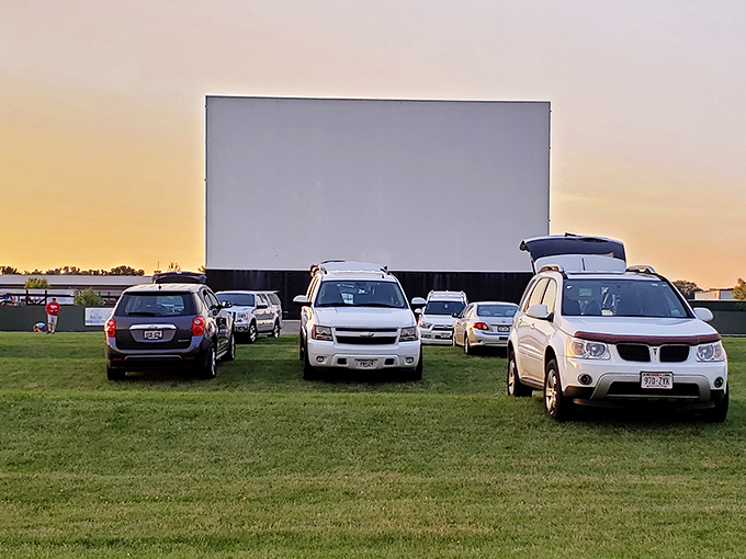A colorful cartoon lights up the screen at Field of Scenes, where families enjoy pre-show entertainment. The classic "Merrie Melodies" intro brings smiles to all ages.
